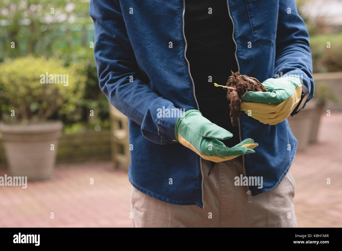 Mid section of man examining soil Stock Photo - Alamy