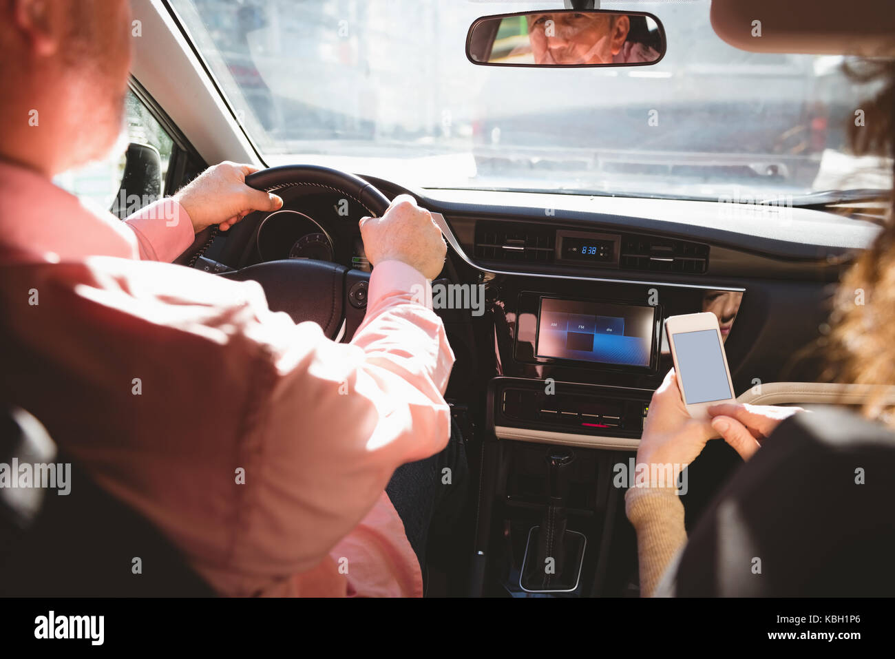 Close-up of couple using mobile phone while travelling in car Stock ...