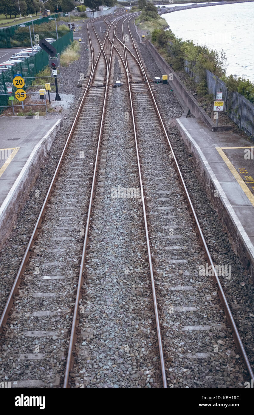 Empty railway track at station Stock Photo - Alamy