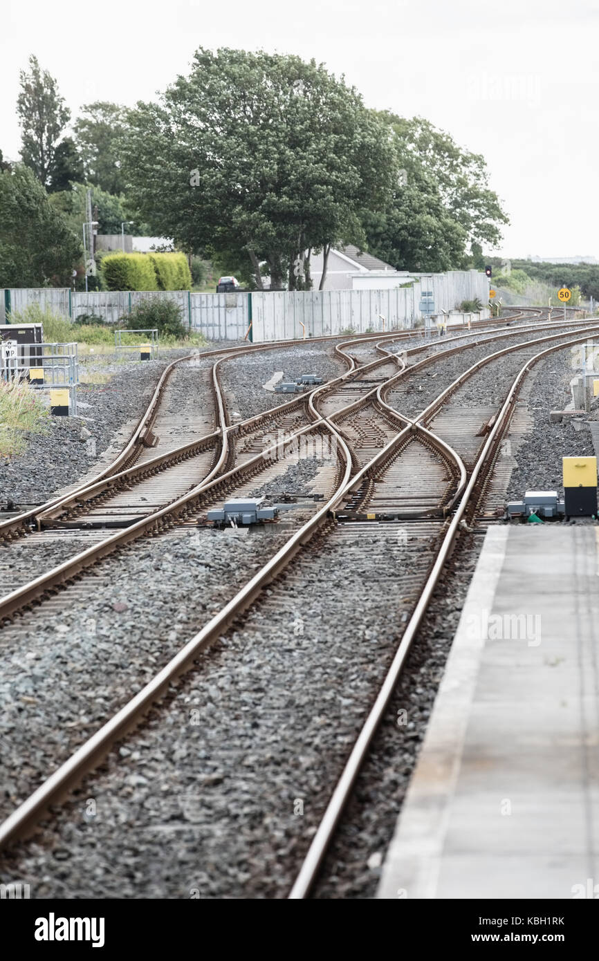 Empty railway track at station Stock Photo - Alamy