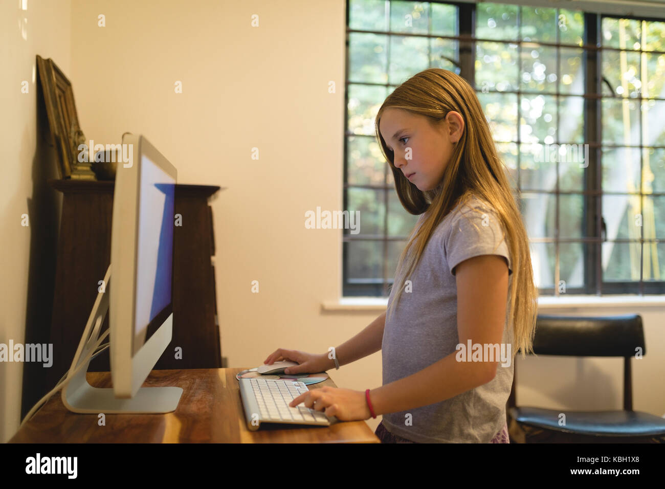 Girl using desktop pc at home Stock Photo - Alamy