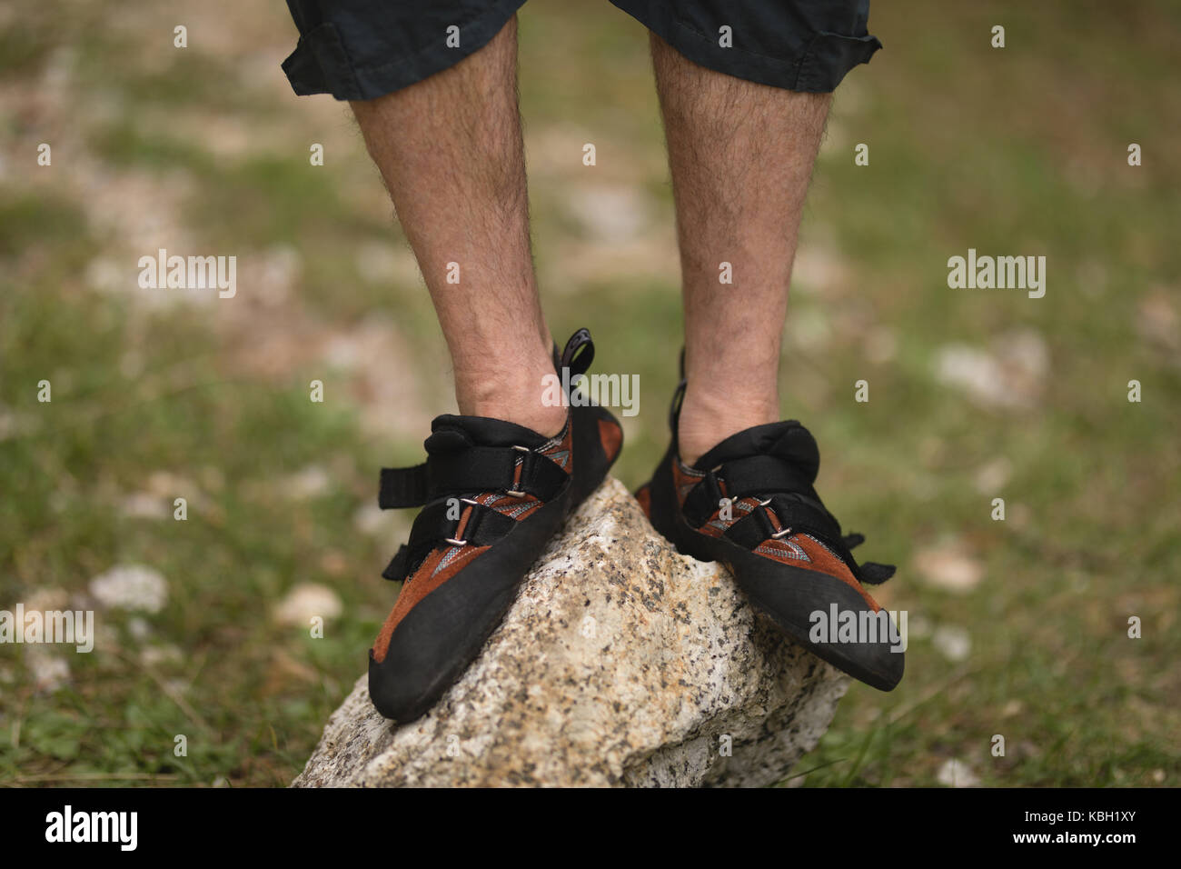 Low section of man standing on rock Stock Photo - Alamy