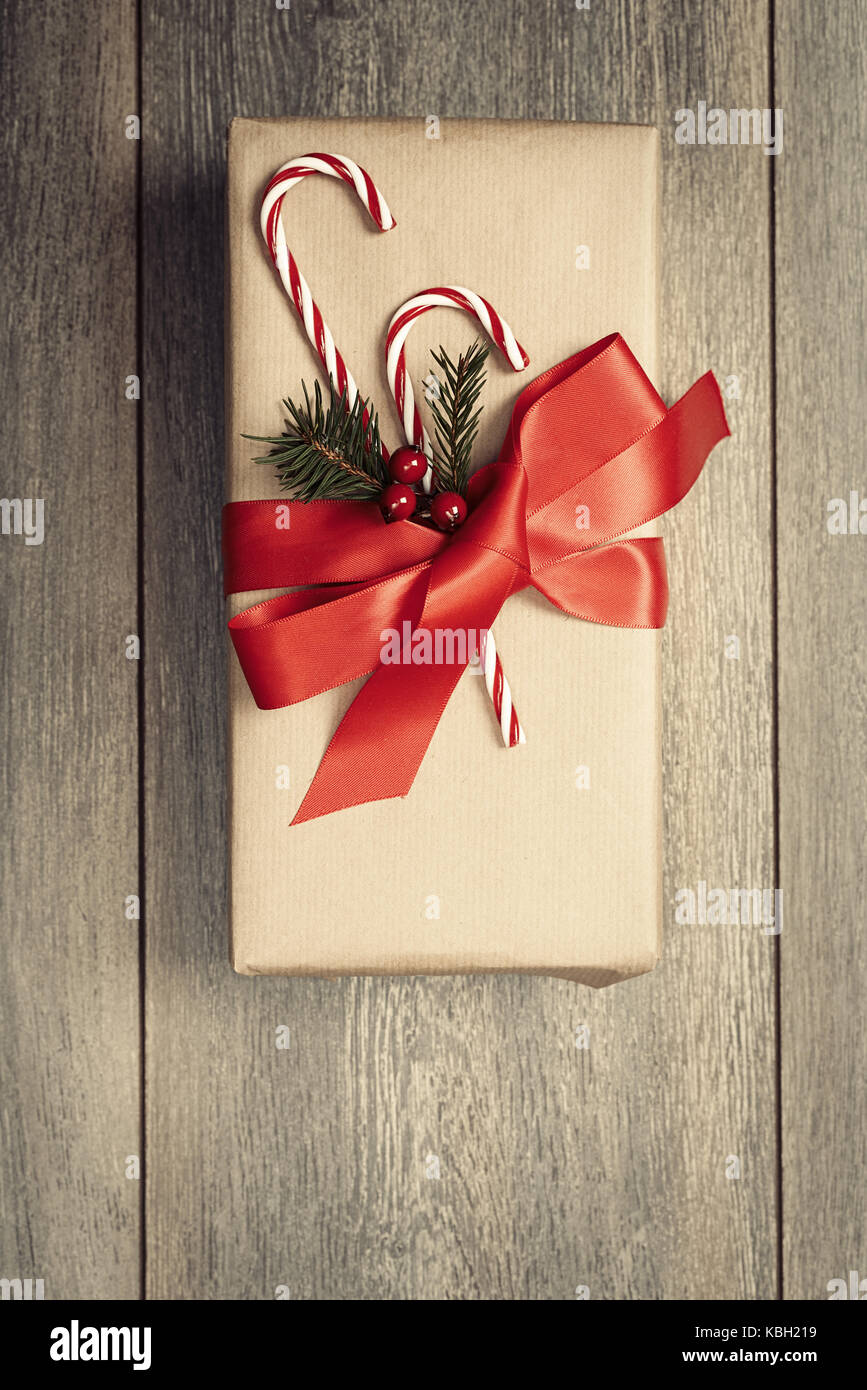 Christmas gift wrapped and tied with red ribbon and candy canes Stock ...
