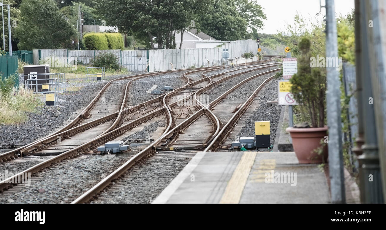 Empty railway track at station Stock Photo - Alamy