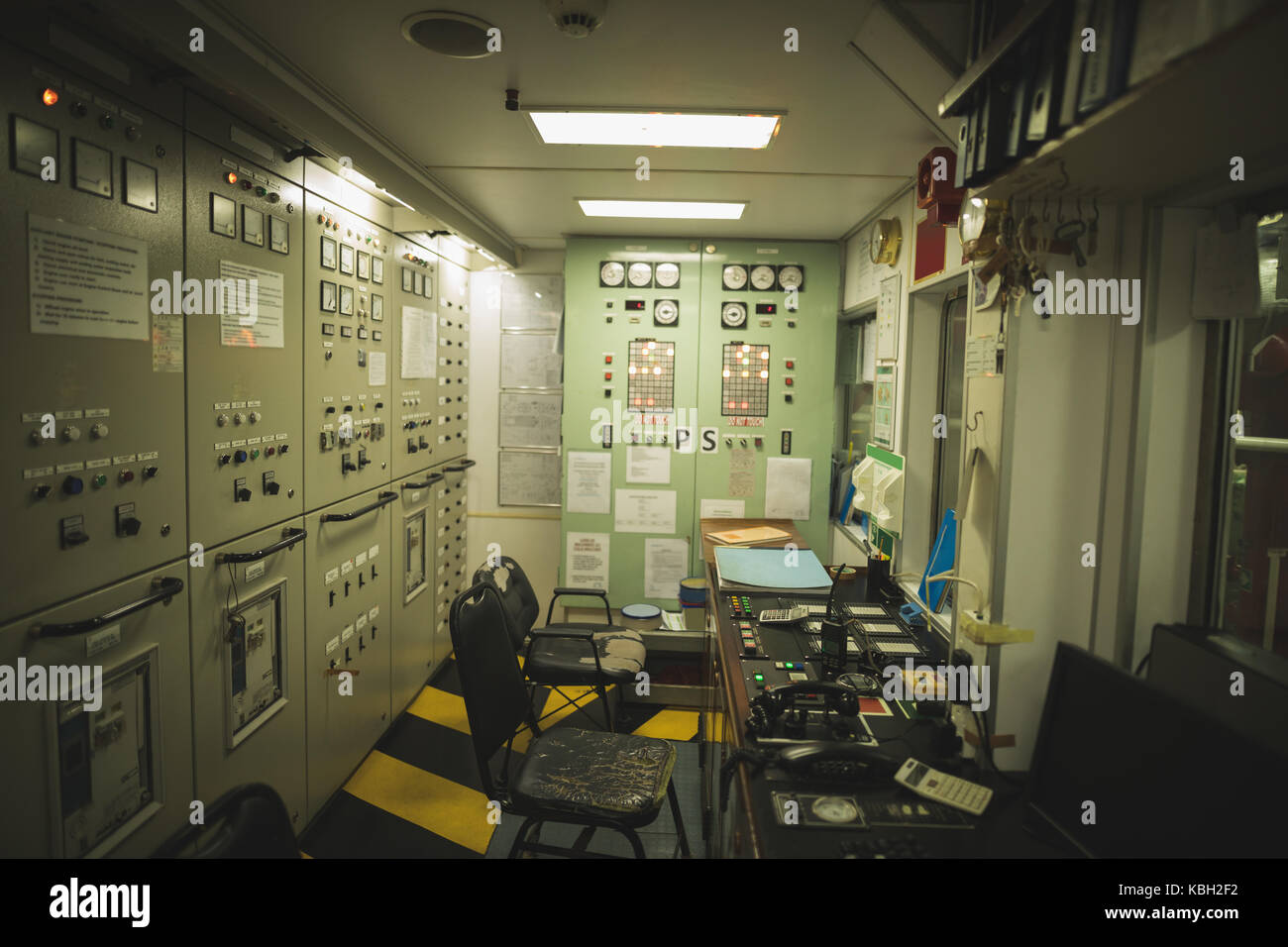 Empty chairs in engine control room in ship Stock Photo - Alamy