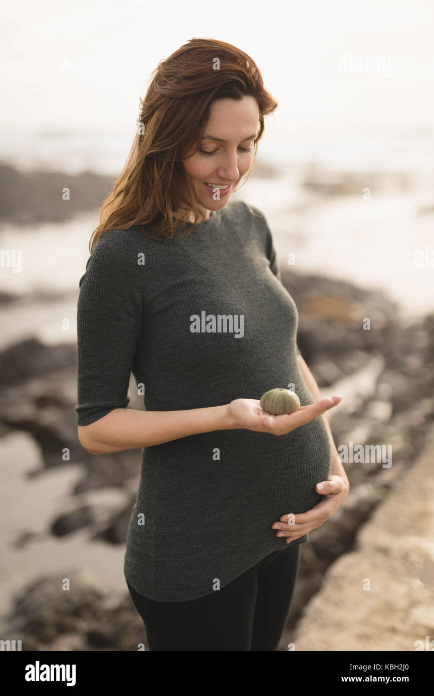 Woman holding shell hi-res stock photography and images - Alamy
