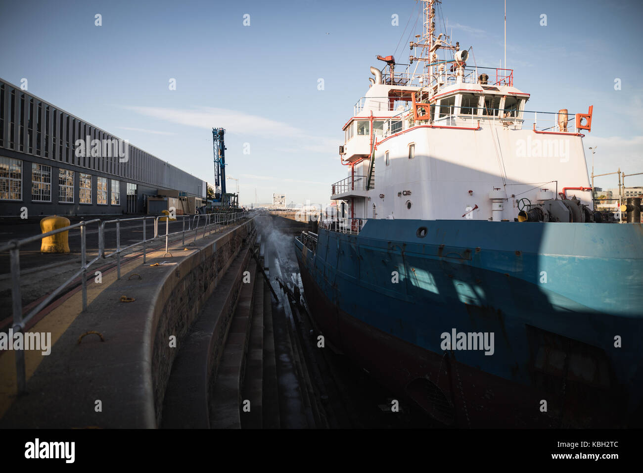 Ship departing at harbor on a sunny day Stock Photo - Alamy