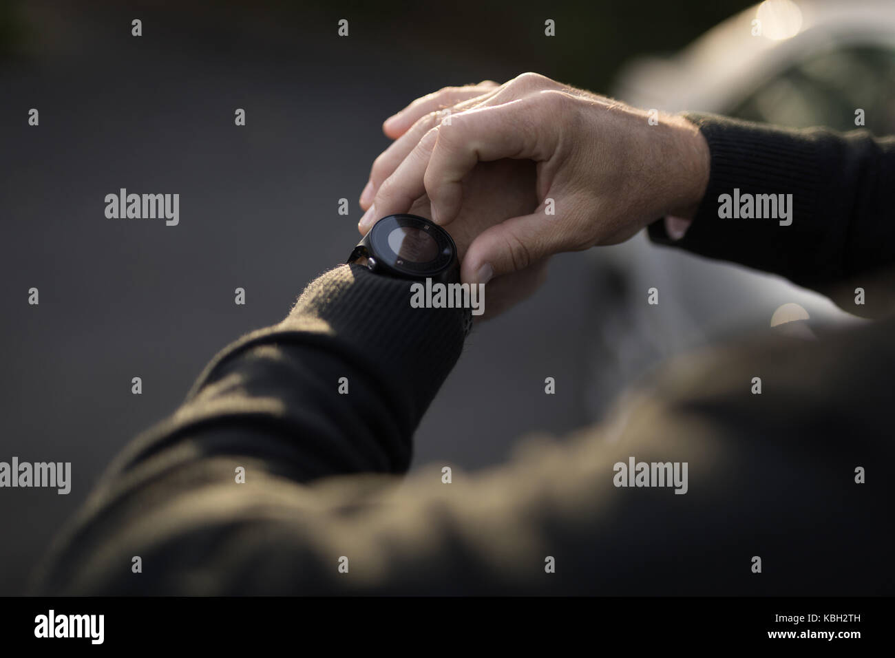 Mid-section of senior man checking time on his watch Stock Photo - Alamy