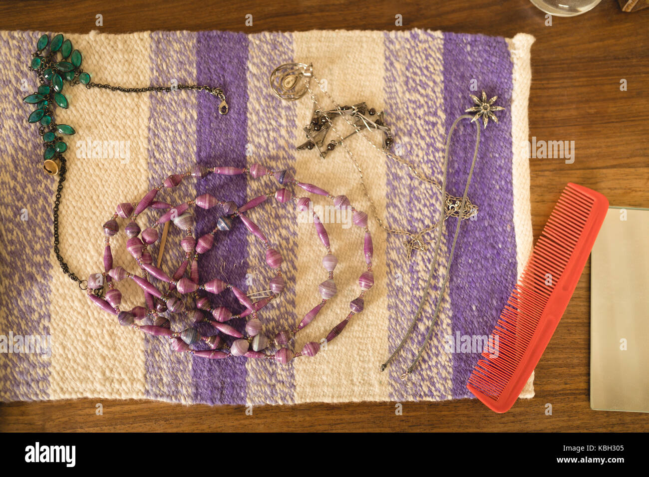 Set of jewelry on wooden table at home Stock Photo - Alamy