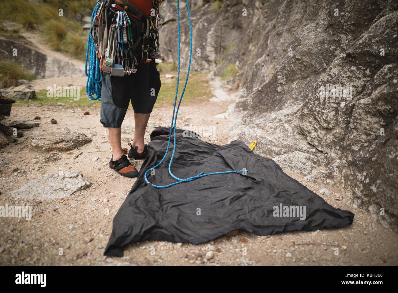 Mid-section of hiker arranging climbing rope Stock Photo - Alamy