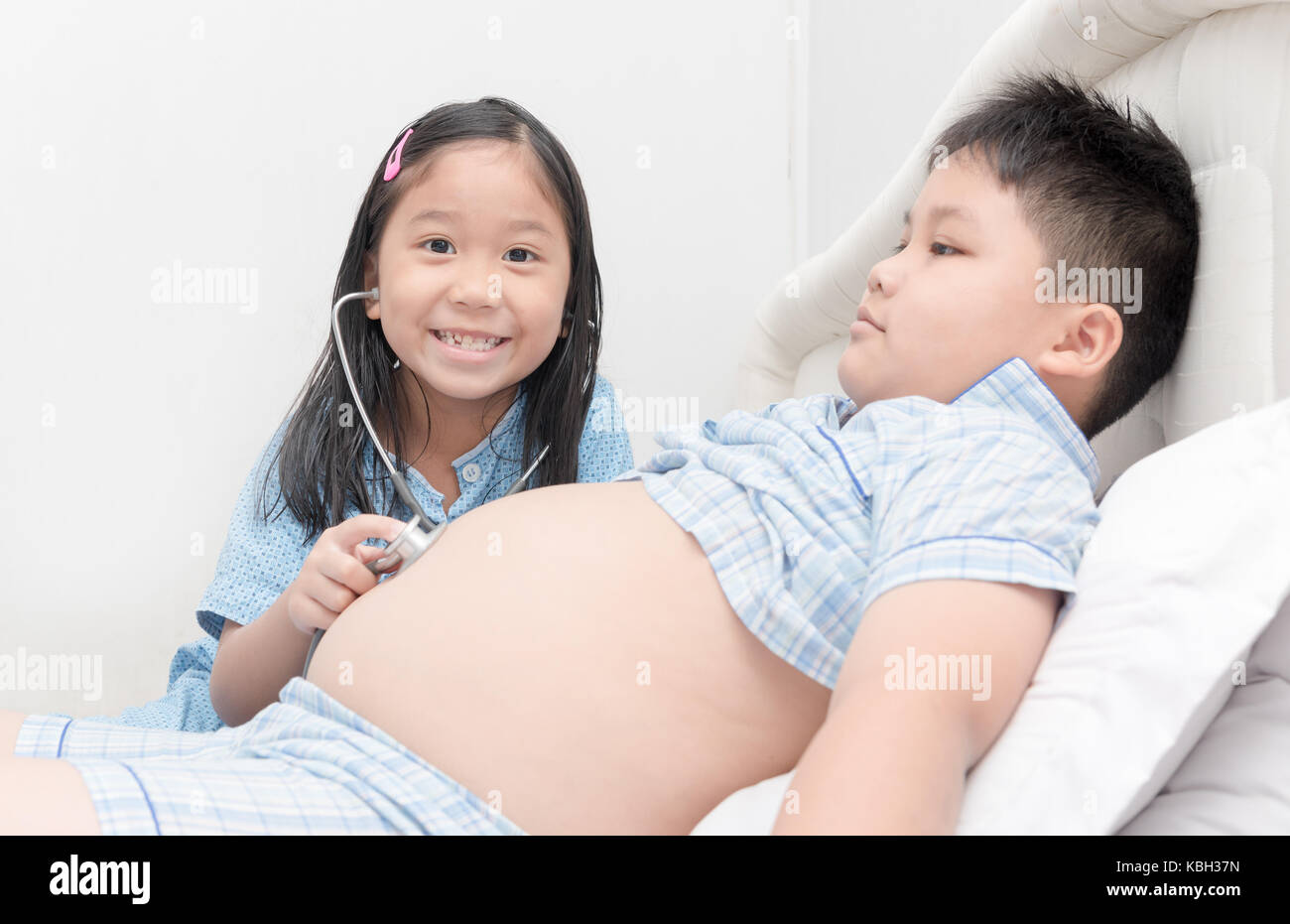 Cute girl check big stomach by stethoscope her brother,obese and ...