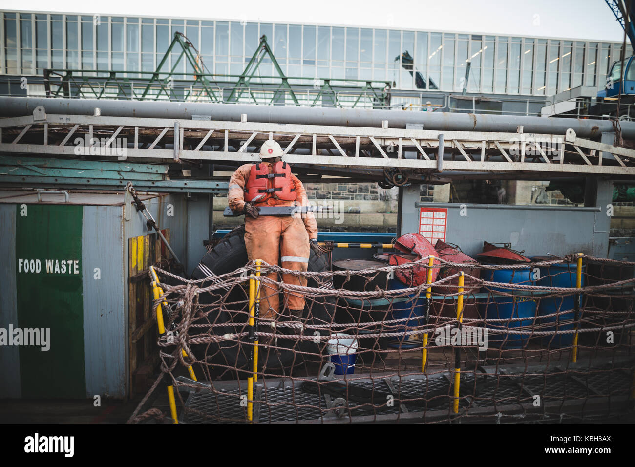 Rear view of crew working on ship Stock Photo - Alamy
