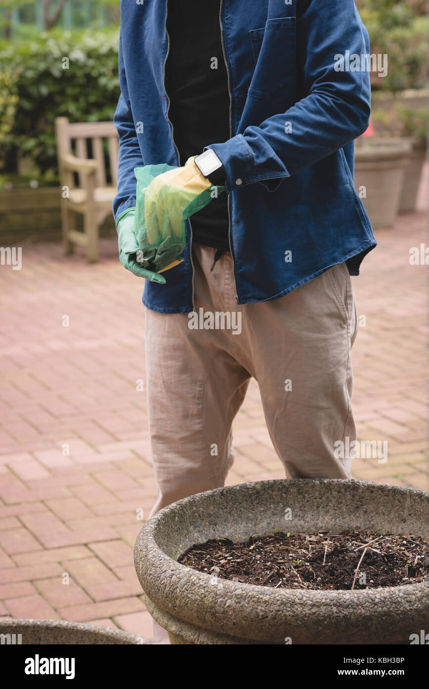 Low section of man mixing fertilizer in soil Stock Photo - Alamy