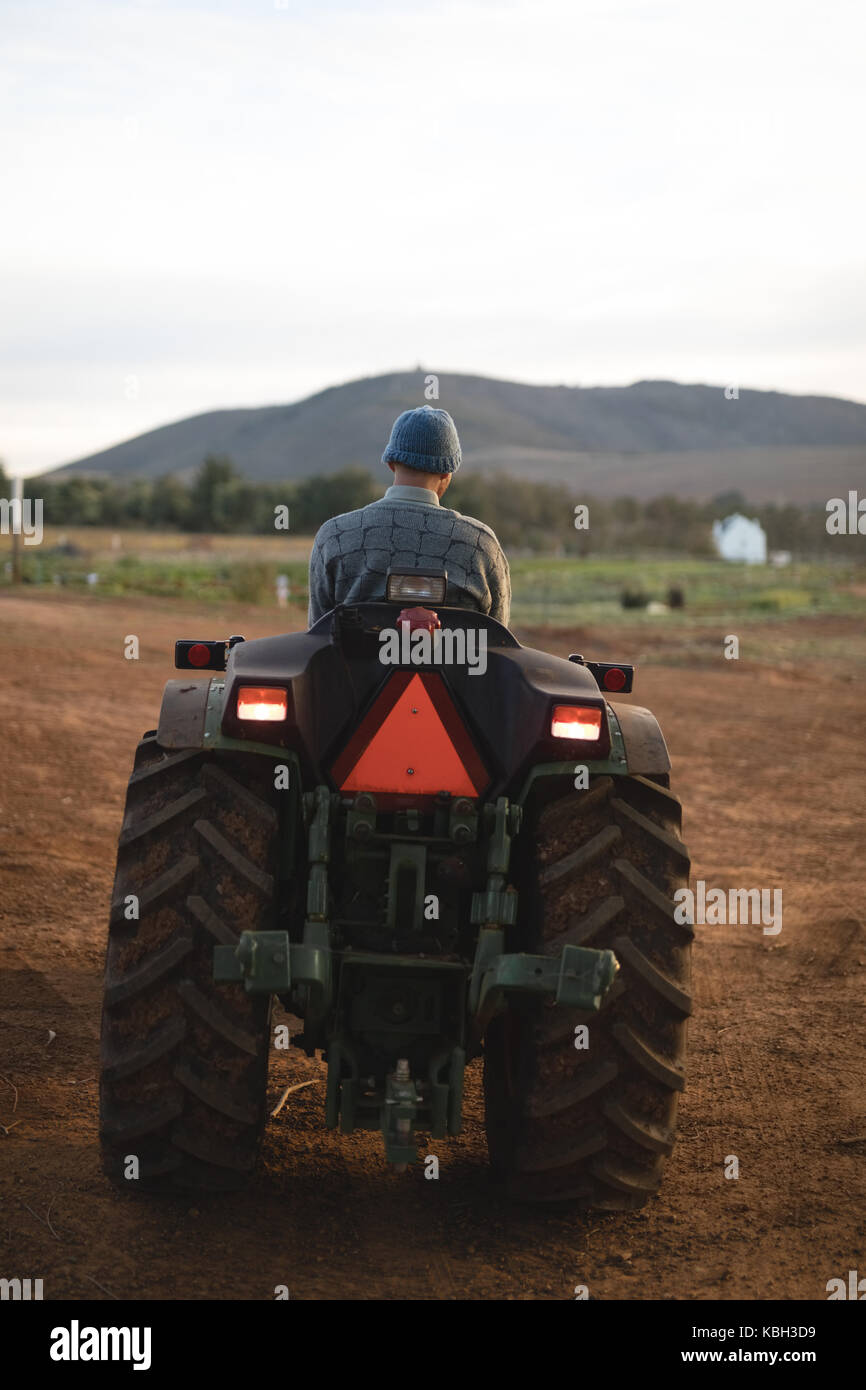 Farmer sitting on tractor on a sunny day Stock Photo - Alamy