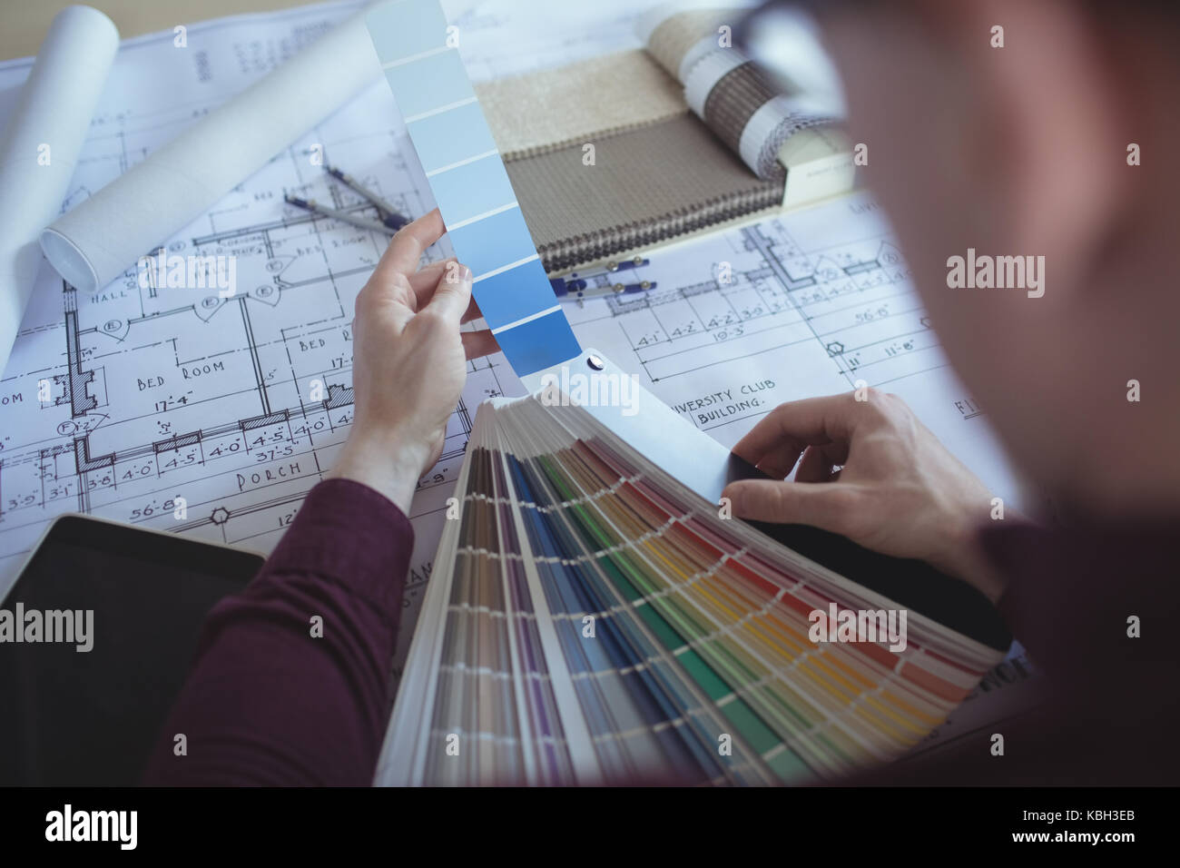 Architect looking at sample in studio Stock Photo - Alamy