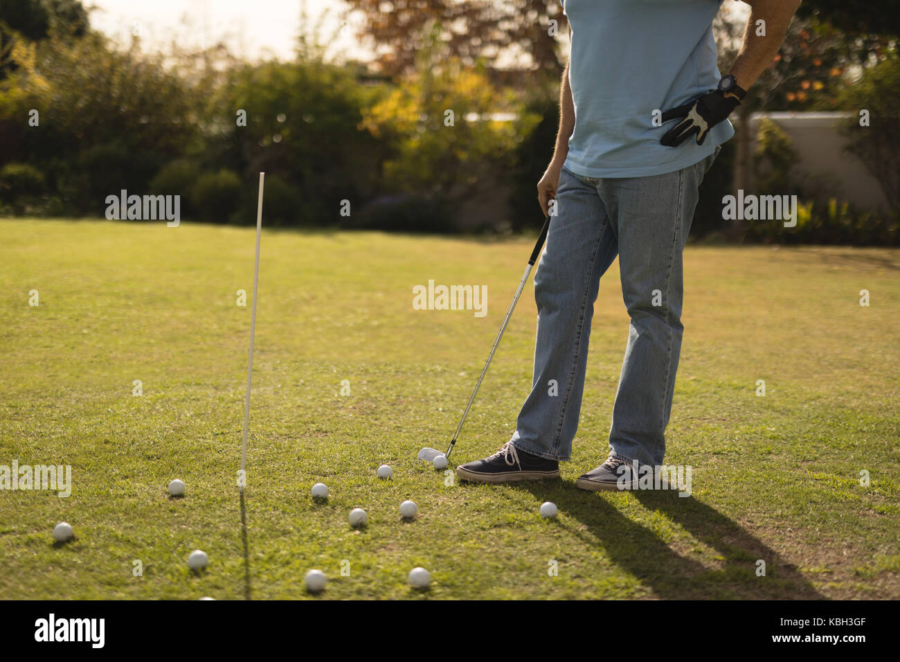 Mid-section of senior man standing in golf course Stock Photo - Alamy