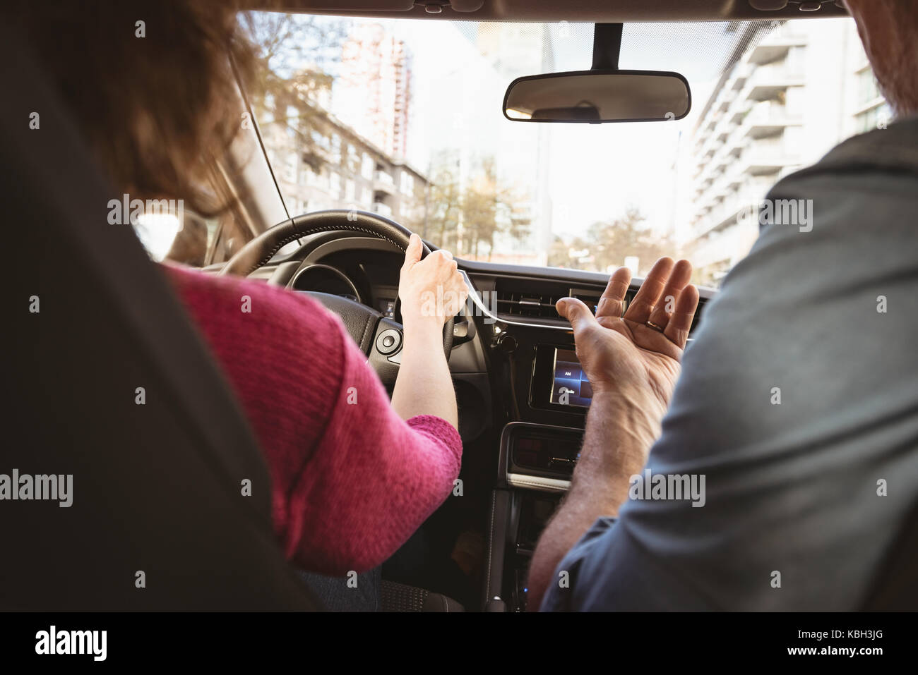 Couple interacting with each other while driving car Stock Photo - Alamy