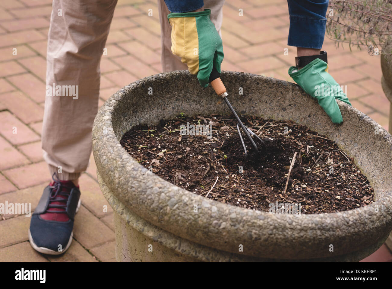 Low section of man digging soil with tool on a sunny day Stock Photo ...