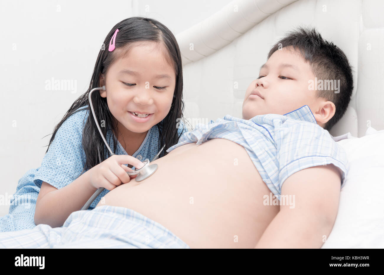 Cute girl check big stomach by stethoscope her brother,obese and ...