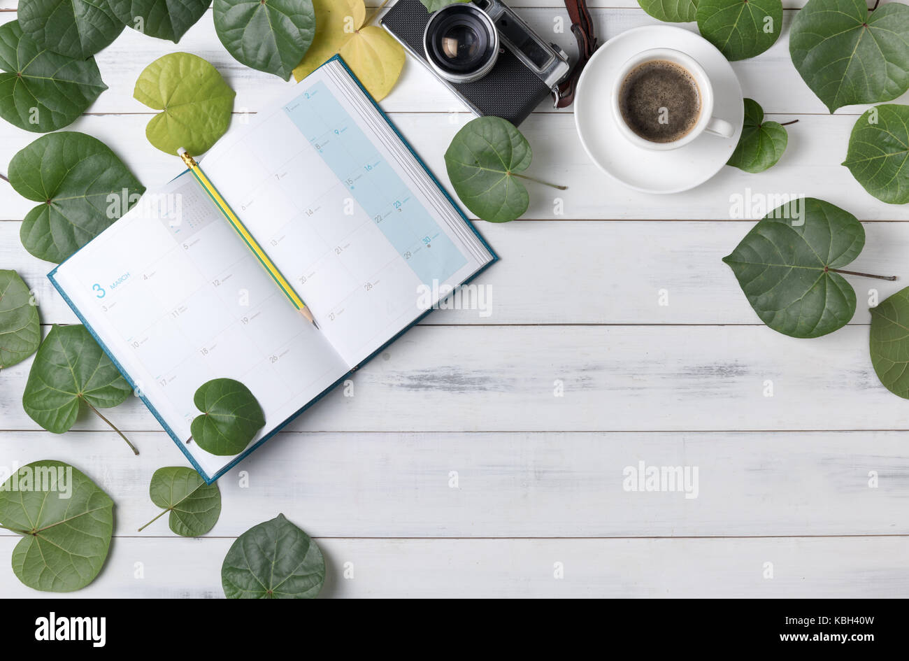 blank calendar notebook with heart shaped green leaf and coffee ...