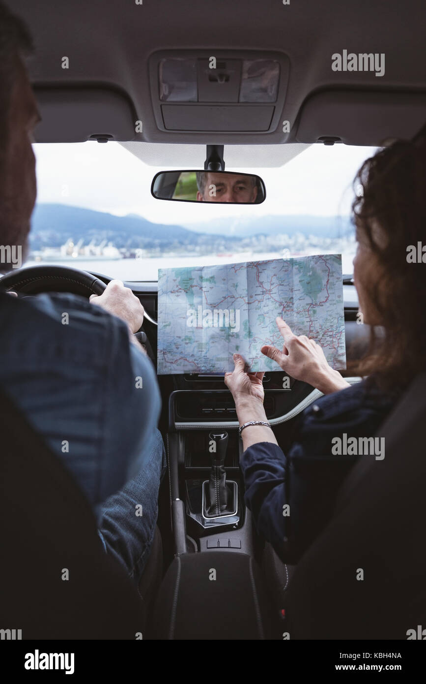 Couple discussing map while driving Stock Photo - Alamy