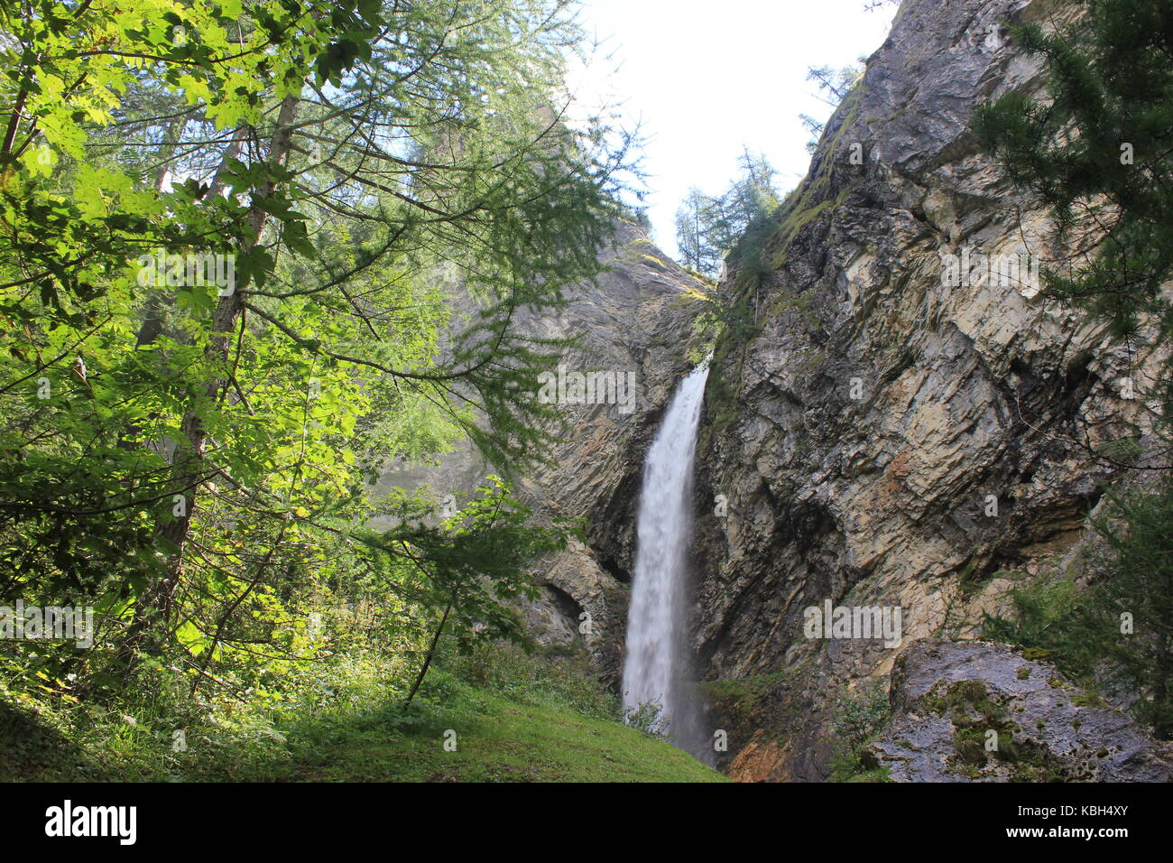 MADESIMO, ITALY - AUGUST 18 2014: Waterfall through rocks in Madesimo ...