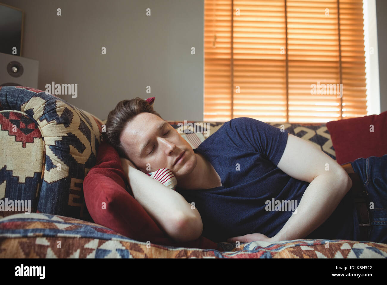 Man sleeping on sofa at home Stock Photo - Alamy