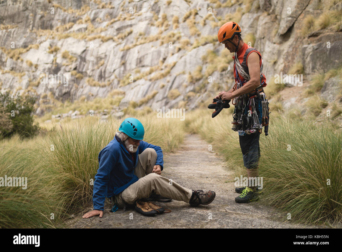 Tired man sitting on the road while hiking Stock Photo - Alamy