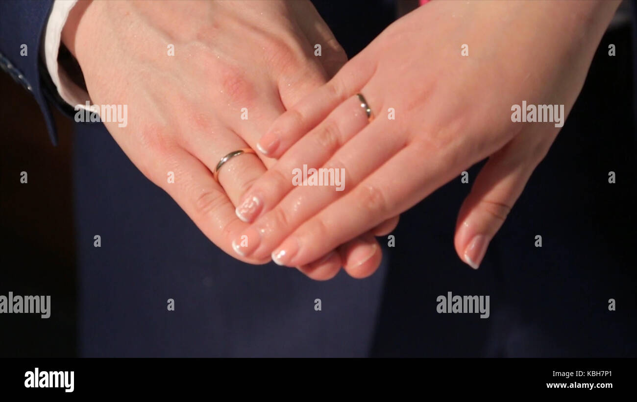 Newly wed couple's hands with wedding rings. Bride and groom with ...