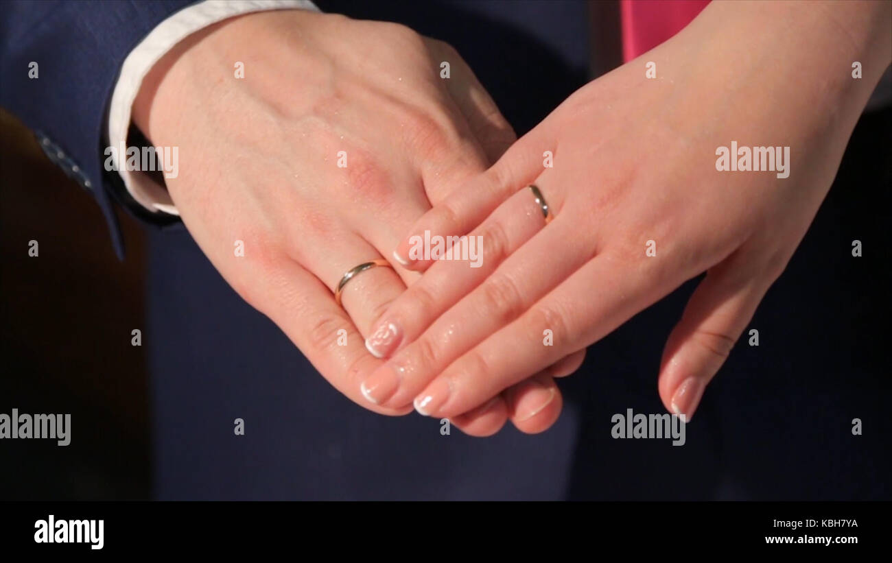 Newly wed couple's hands with wedding rings. Bride and groom with ...
