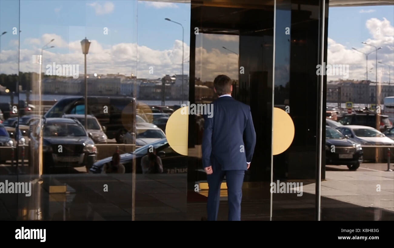 Handsome Business Man Entering Building through Revolving Doors ...