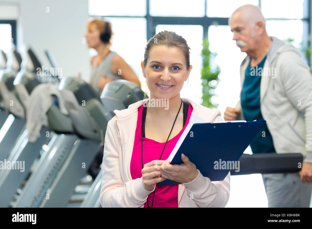 beautiful female personal trainer at gym Stock Photo - Alamy