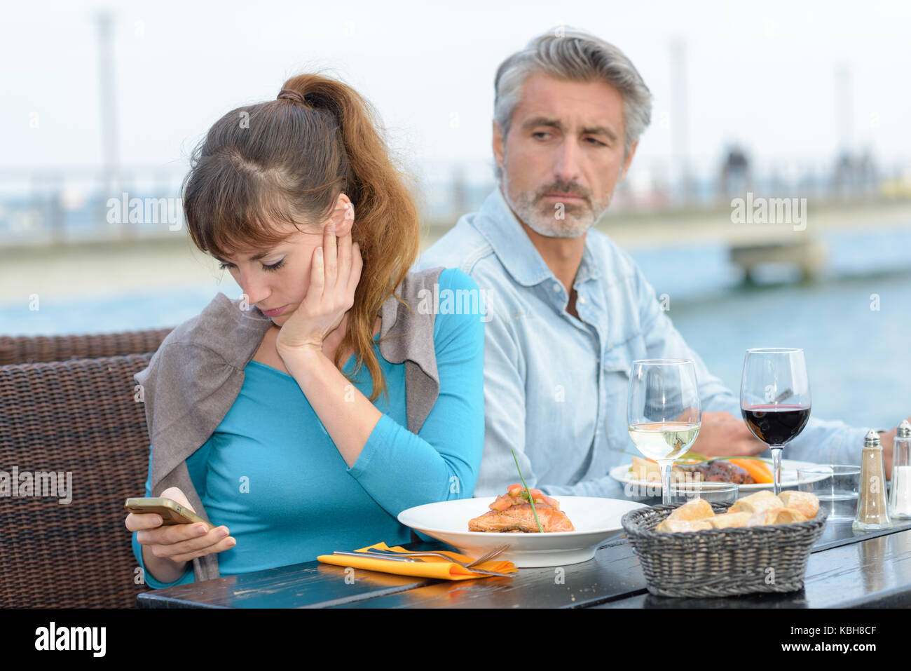woman disregarding the partner during meal Stock Photo - Alamy