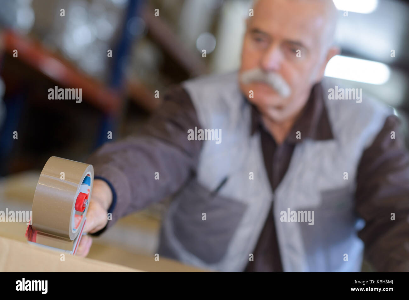 taping the box for delivery Stock Photo - Alamy