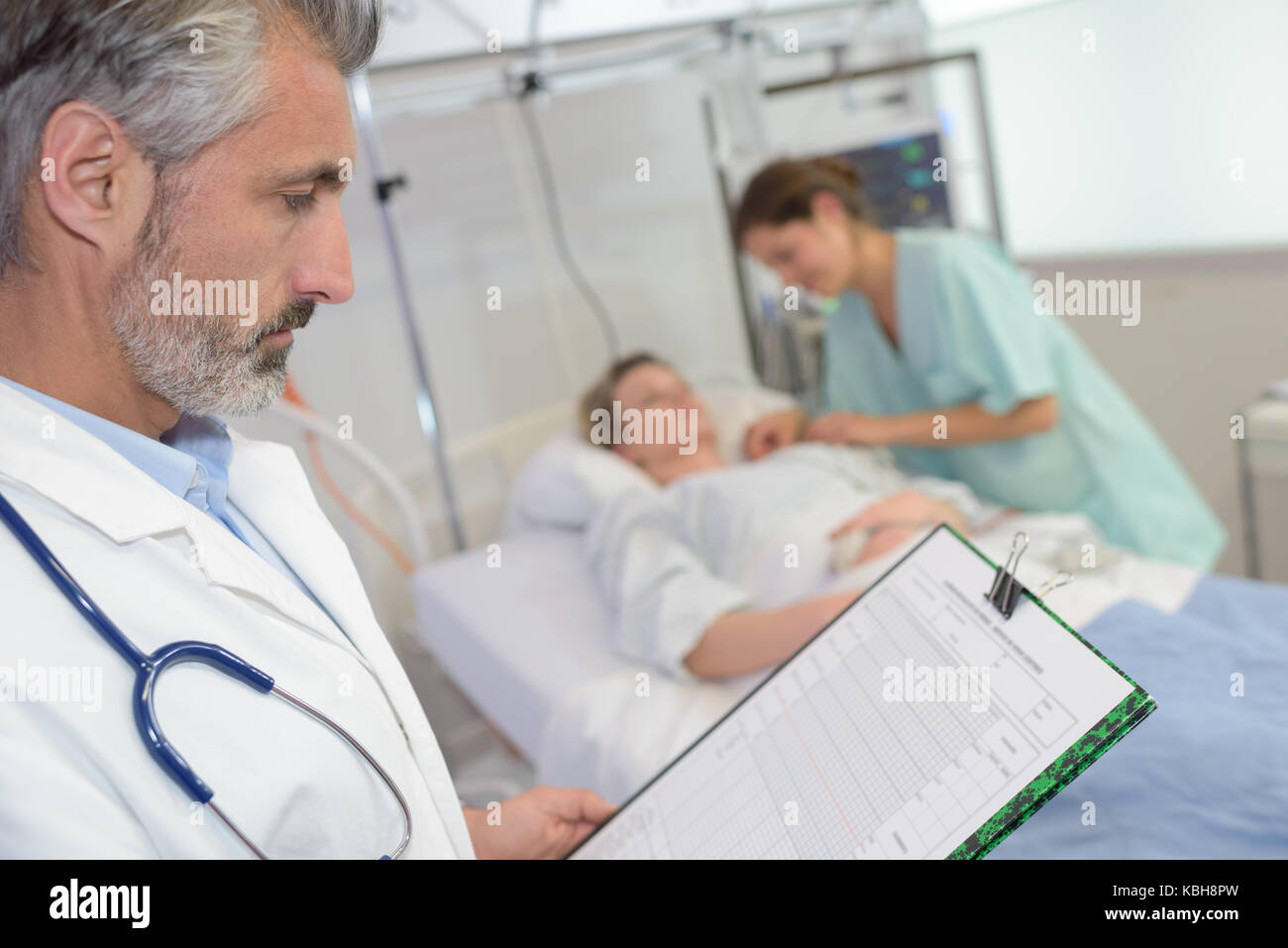 doctor reading the file Stock Photo - Alamy