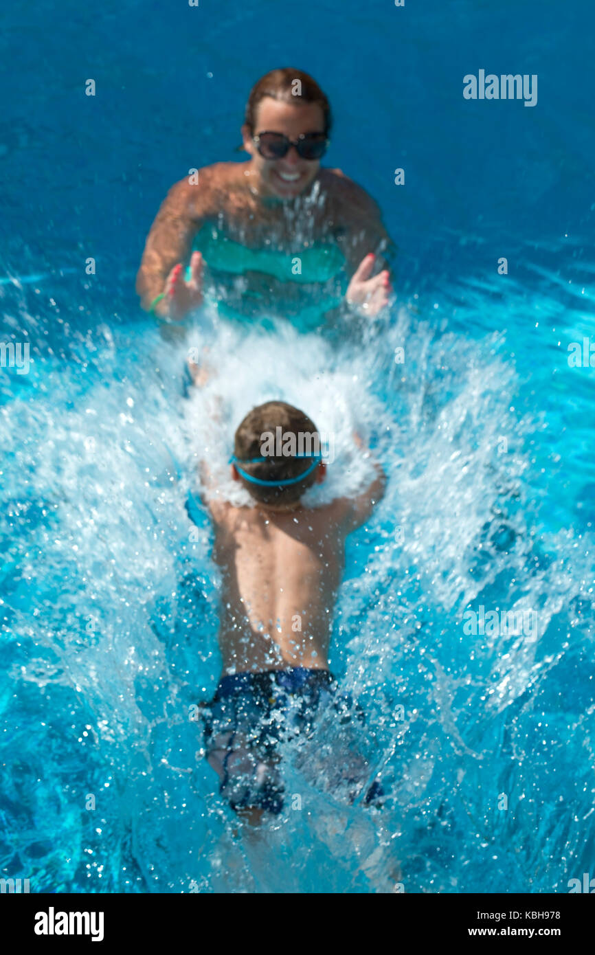 Family jumping into pool hi-res stock photography and images - Alamy