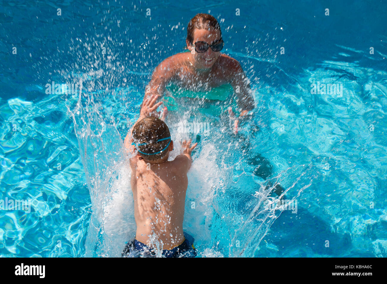 Family jumping in swimming pool hi-res stock photography and images - Alamy