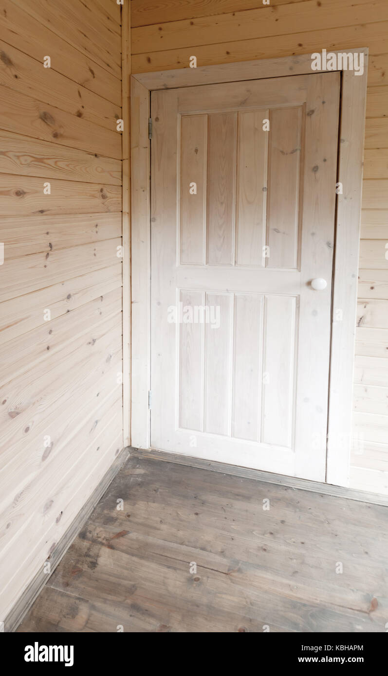 Empty wooden interior fragment, white door in the corner Stock Photo ...