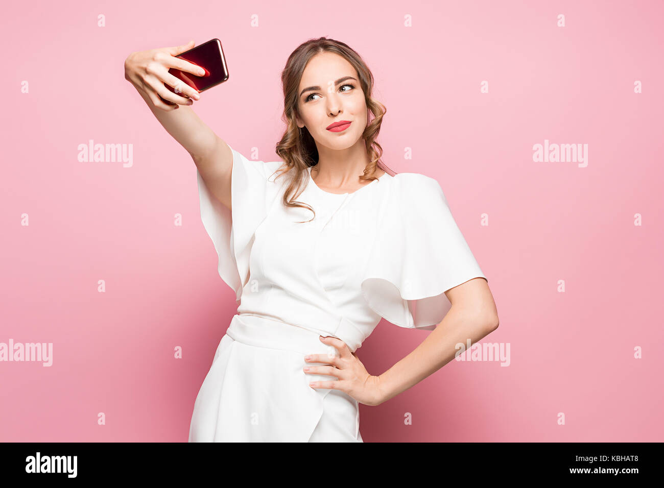 Portrait of a young attractive woman making selfie photo with ...