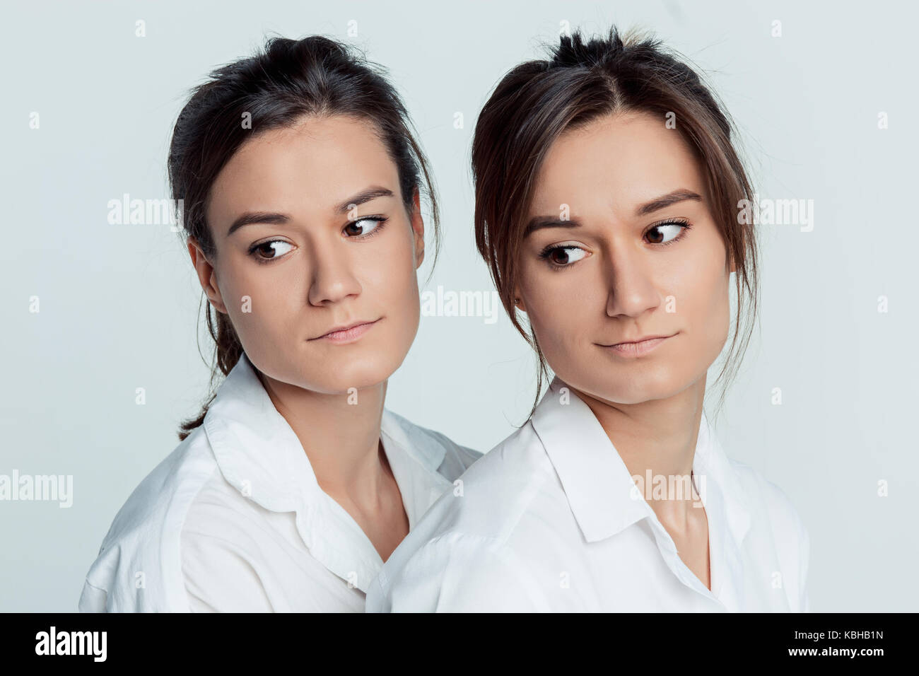 Studio portrait of female twins Stock Photo - Alamy