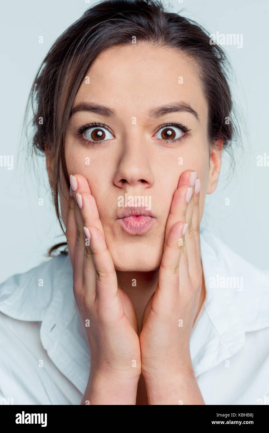 Portrait of young woman with shocked facial expression Stock Photo - Alamy