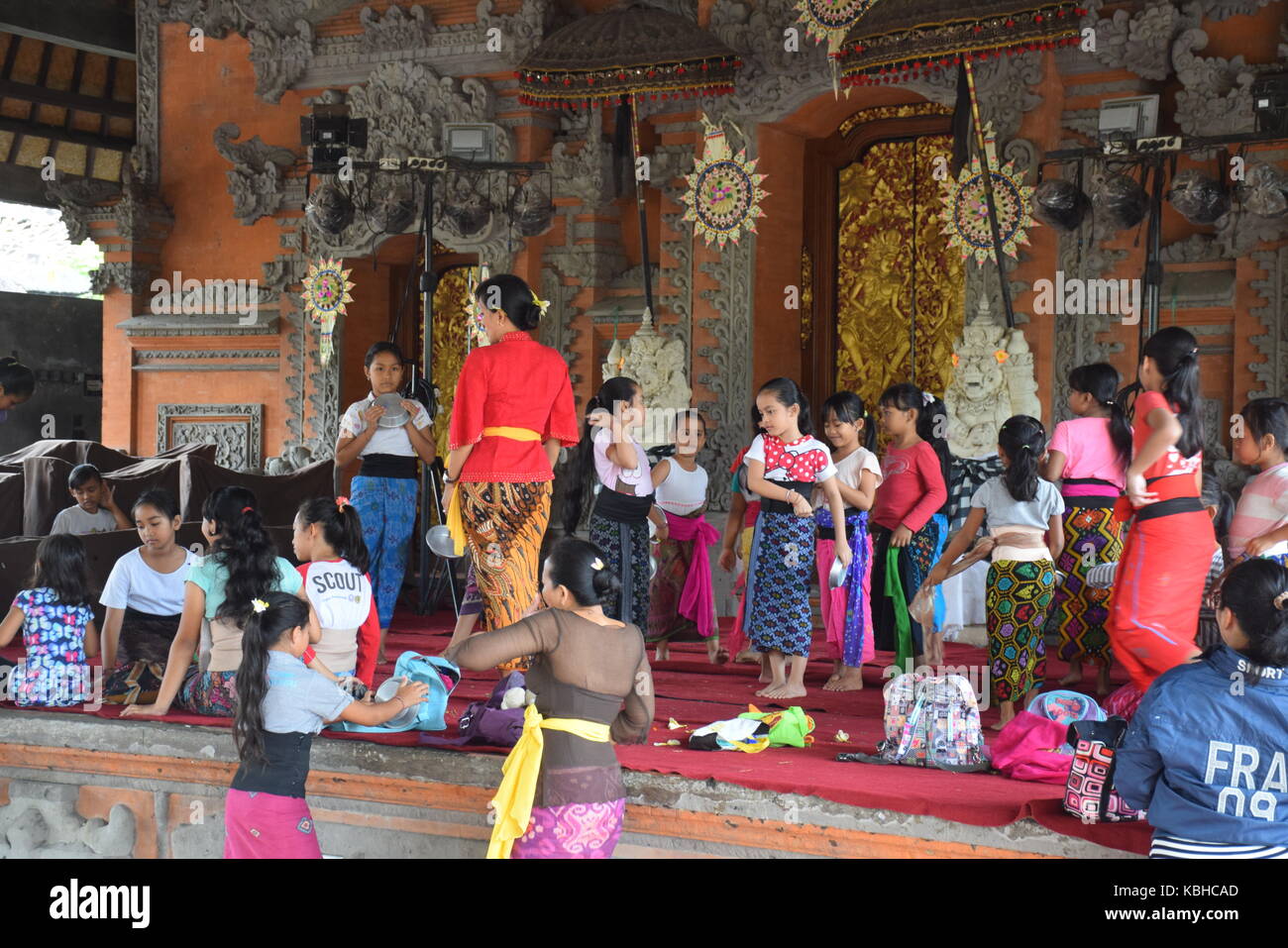 Beautiful indonesian woman teaching balinese dance to young kids in ...