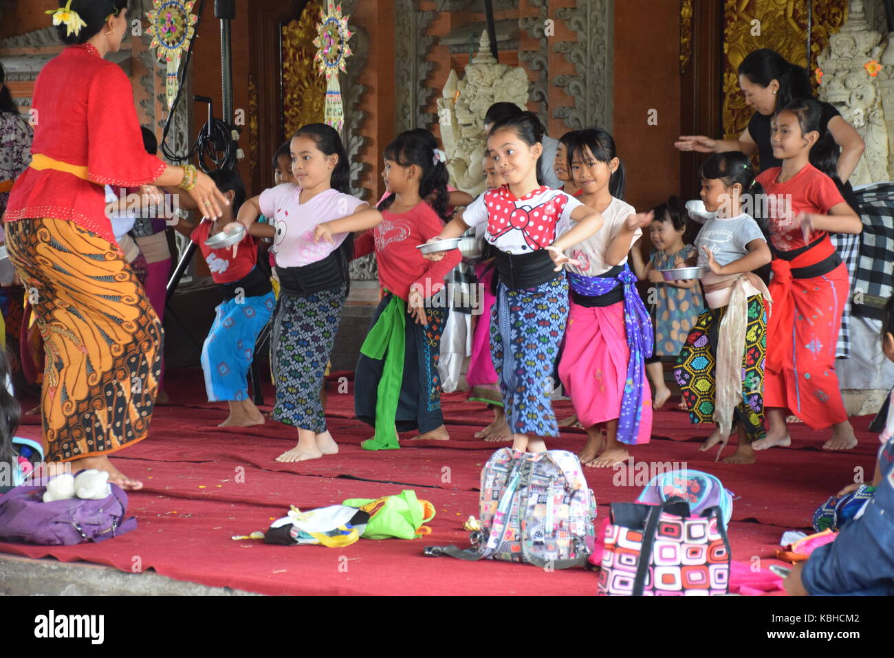 Beautiful indonesian woman teaching balinese dance to young kids in ...