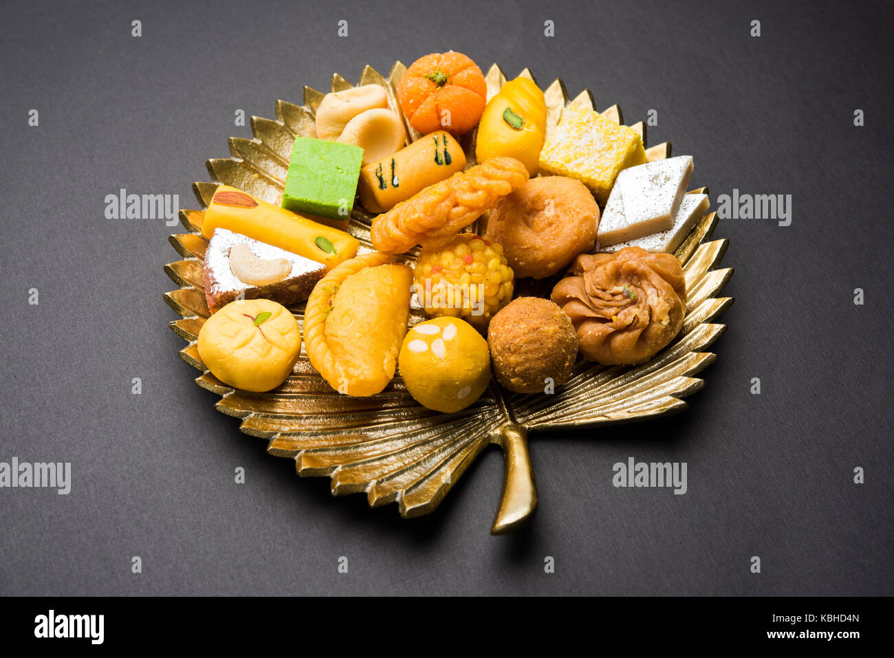 stock photo of Indian sweet or mithai and oil lamps or diya with ...