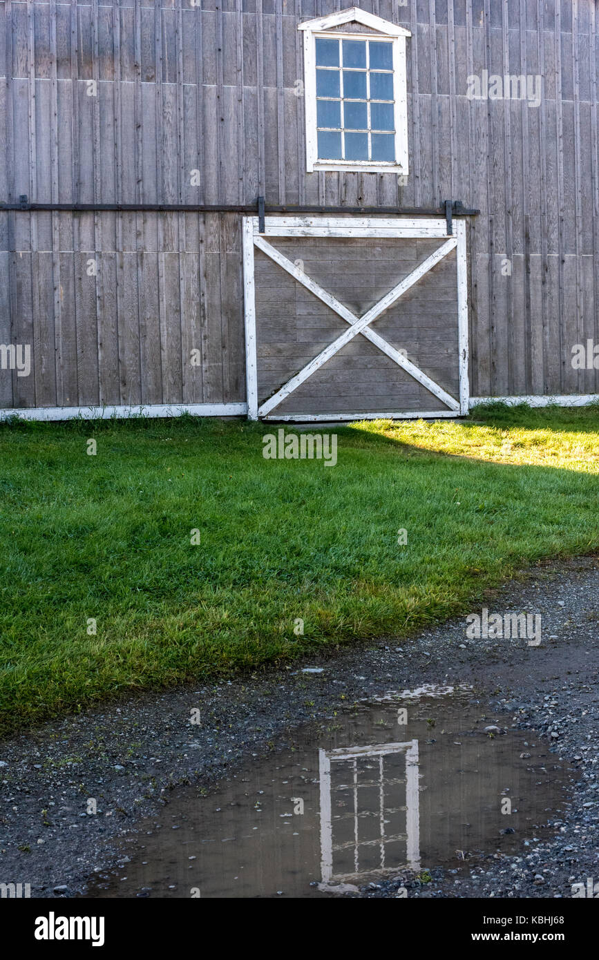 Weathered barn window reflected in puddle Stock Photo - Alamy