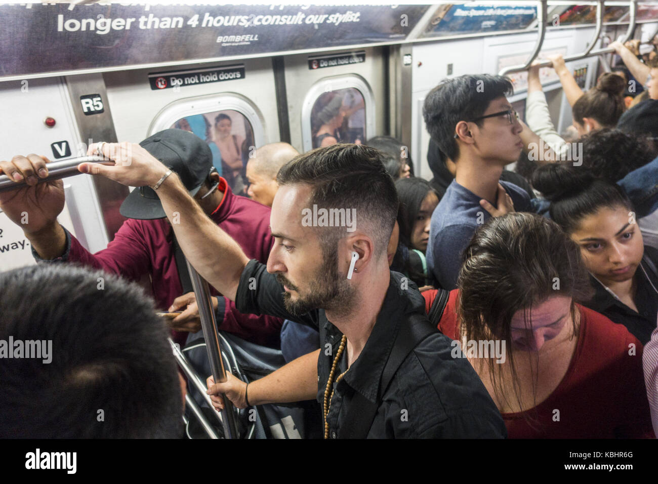 Very crowded F train on its way from Brooklyn to Manhattan during the ...