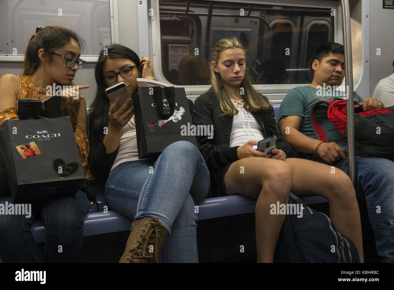 Young people riding a New York City subway train in Manhattan, NYC ...
