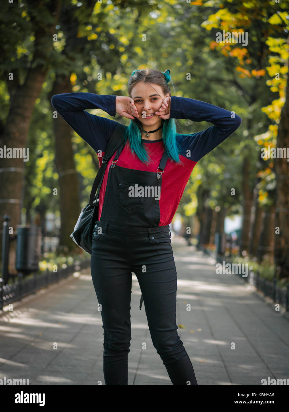 Street punk or hipster girl enjoying empty old European park. Portrait ...