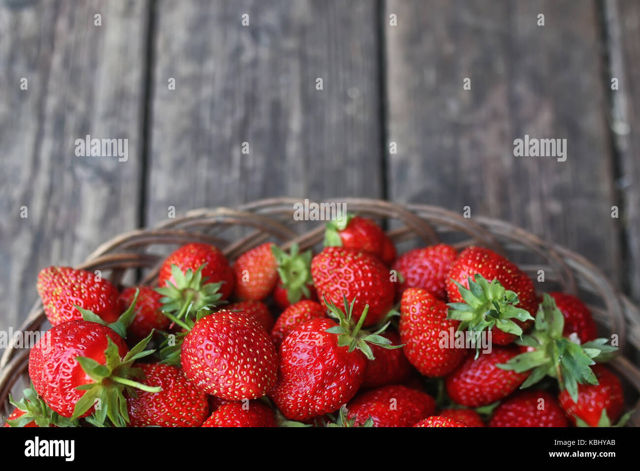 Strawberry on rustic wooden background Stock Photo - Alamy