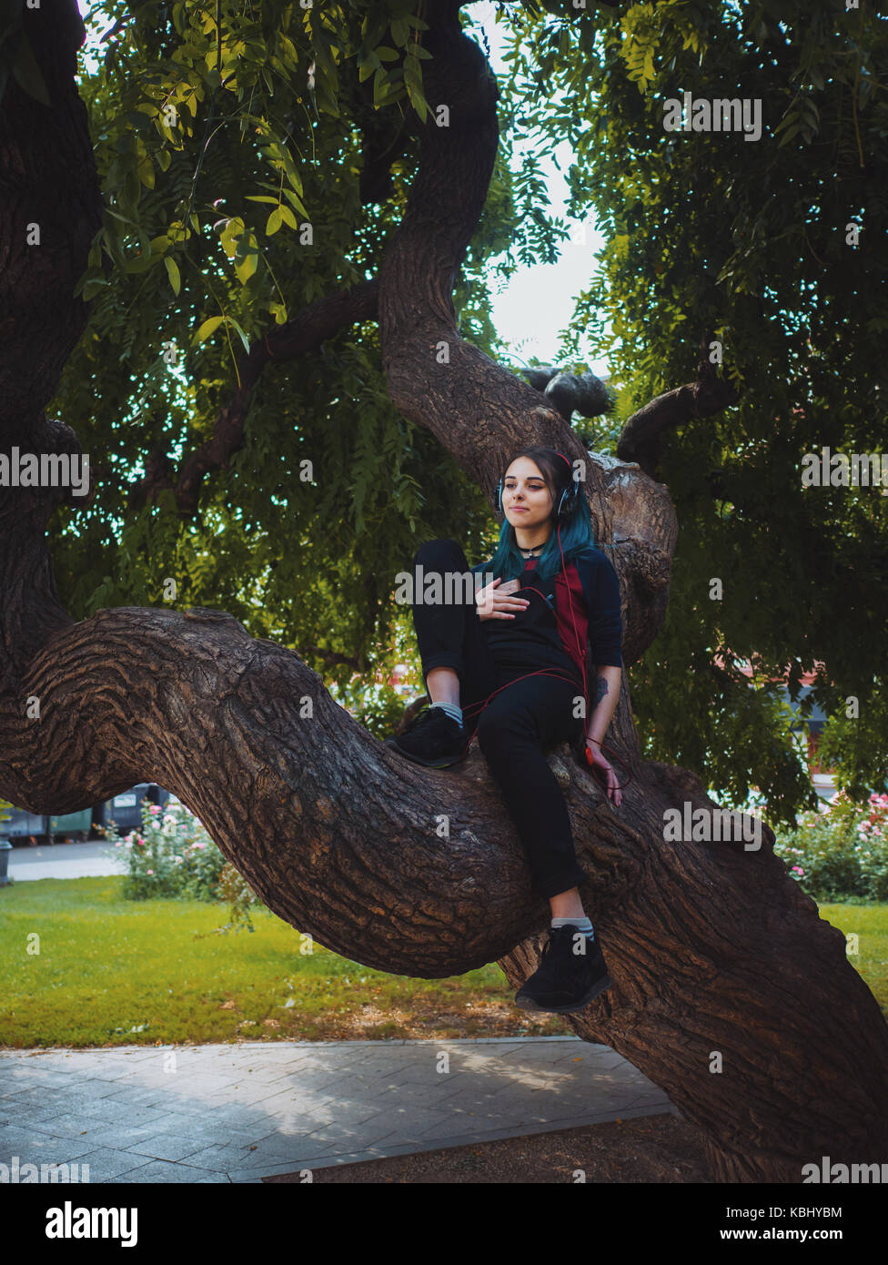 Street punk or hipster girl listening music with black headphones.Teen ...